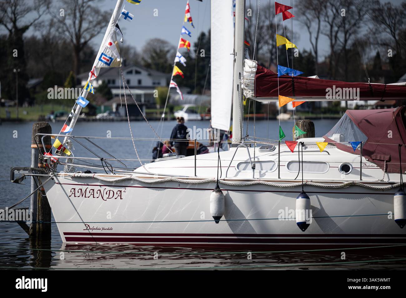 Zeuthen, Germany. 12th Apr, 2025. View of a boat with flags at a jetty ...