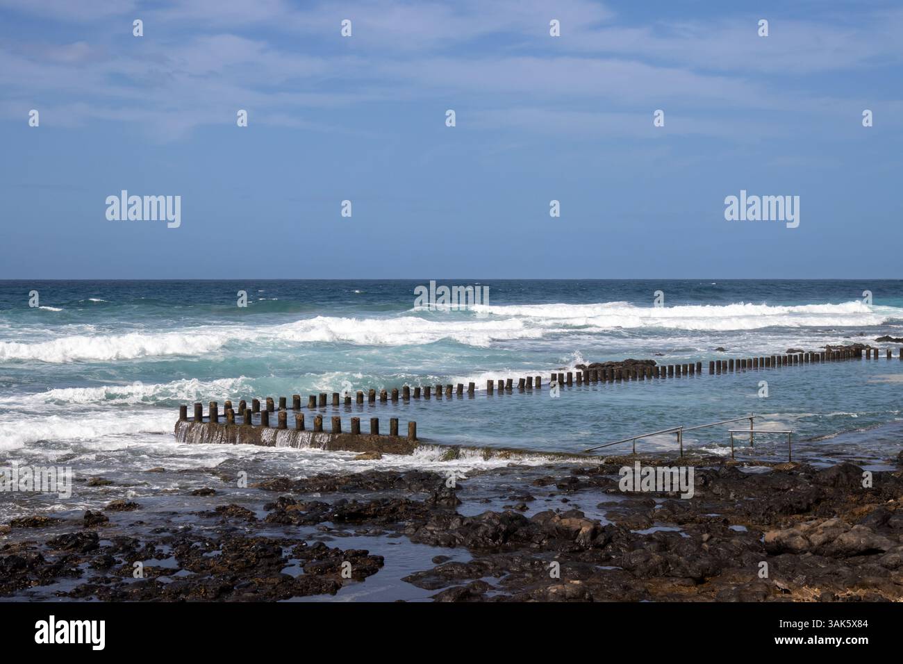 Rocky coast of the Atlantic ocean. Line of a small ocean swimming pool ...