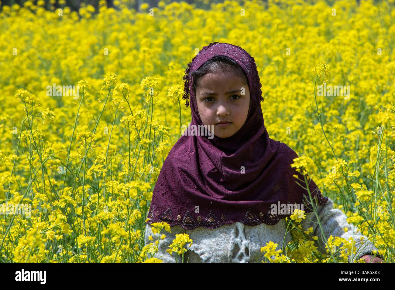 Srinagar, Kashmir, India. 12th Apr, 2025. A young girl stands in a ...