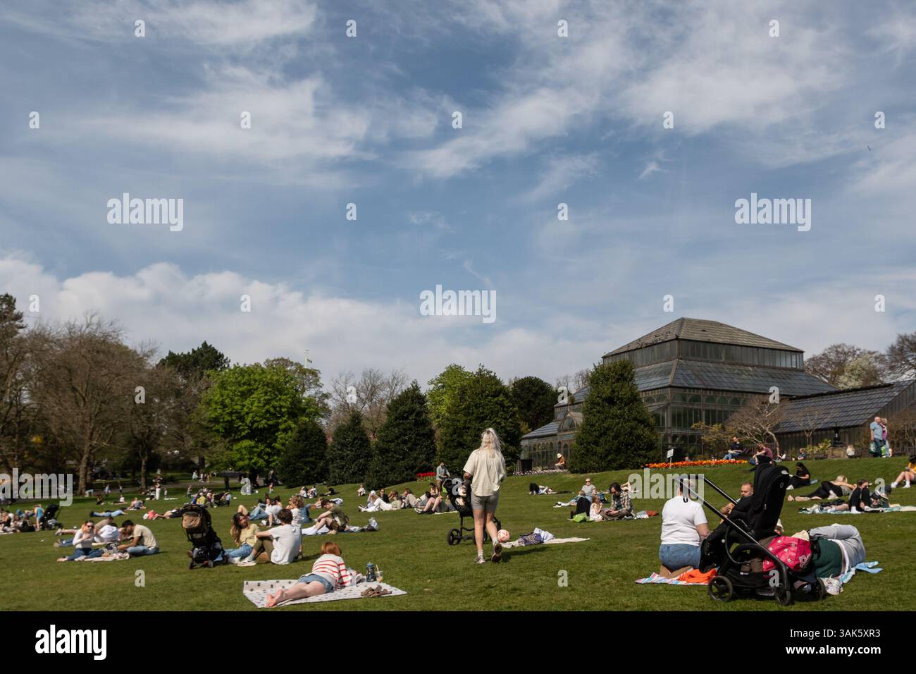 Glasgow, Scotland. 12.04.2025. People flock to outside public space Glasgow Botanic Gardens to ...