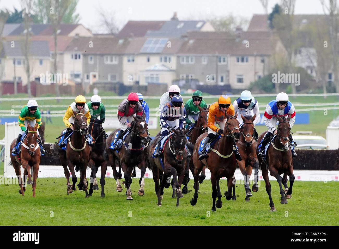 Runners and riders compete in the Coral Scottish Champion Hurdle on day ...