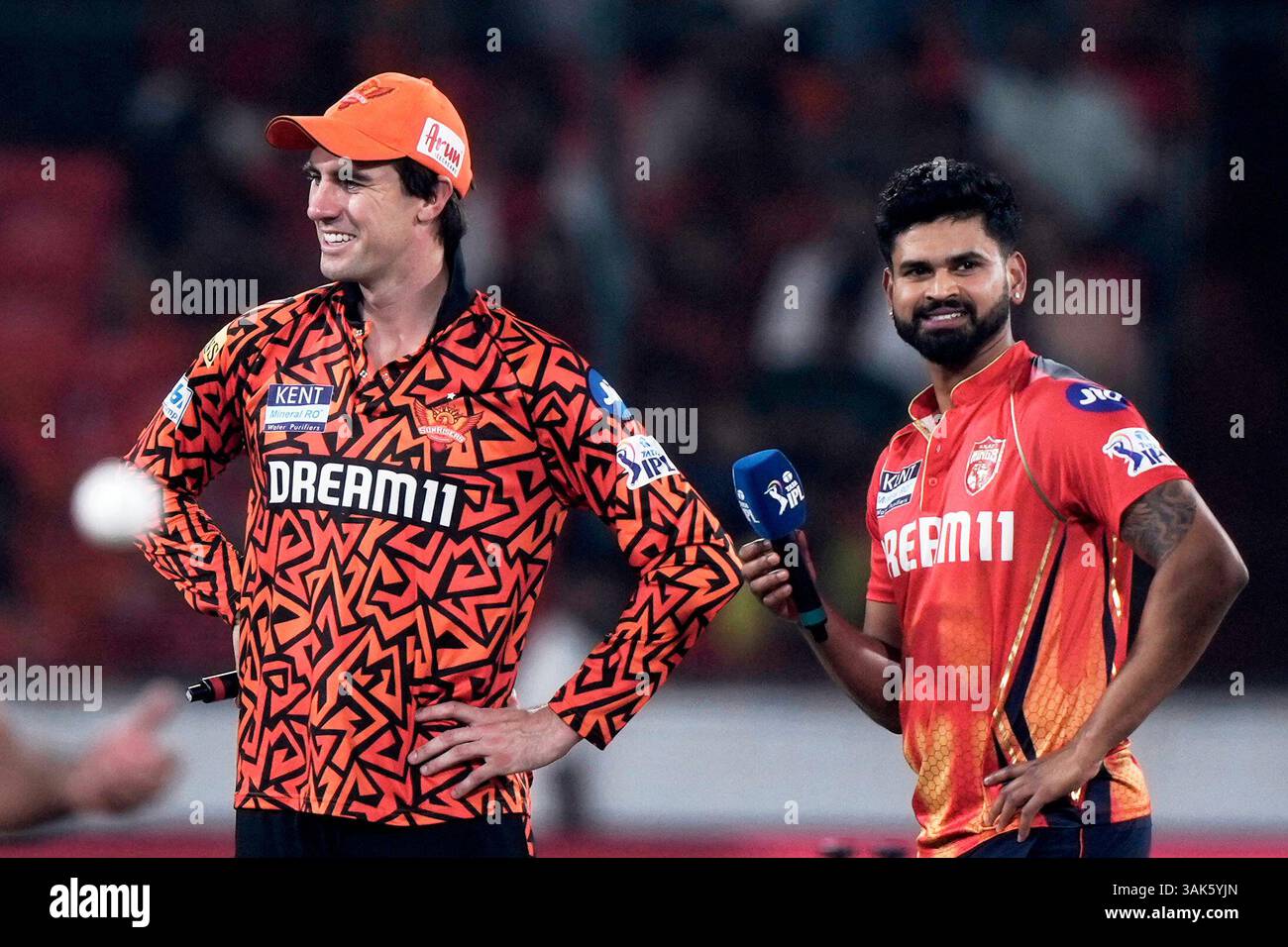 Sunrisers Hyderabad's captain Pat Cummins, left, and Punjab Kings ...
