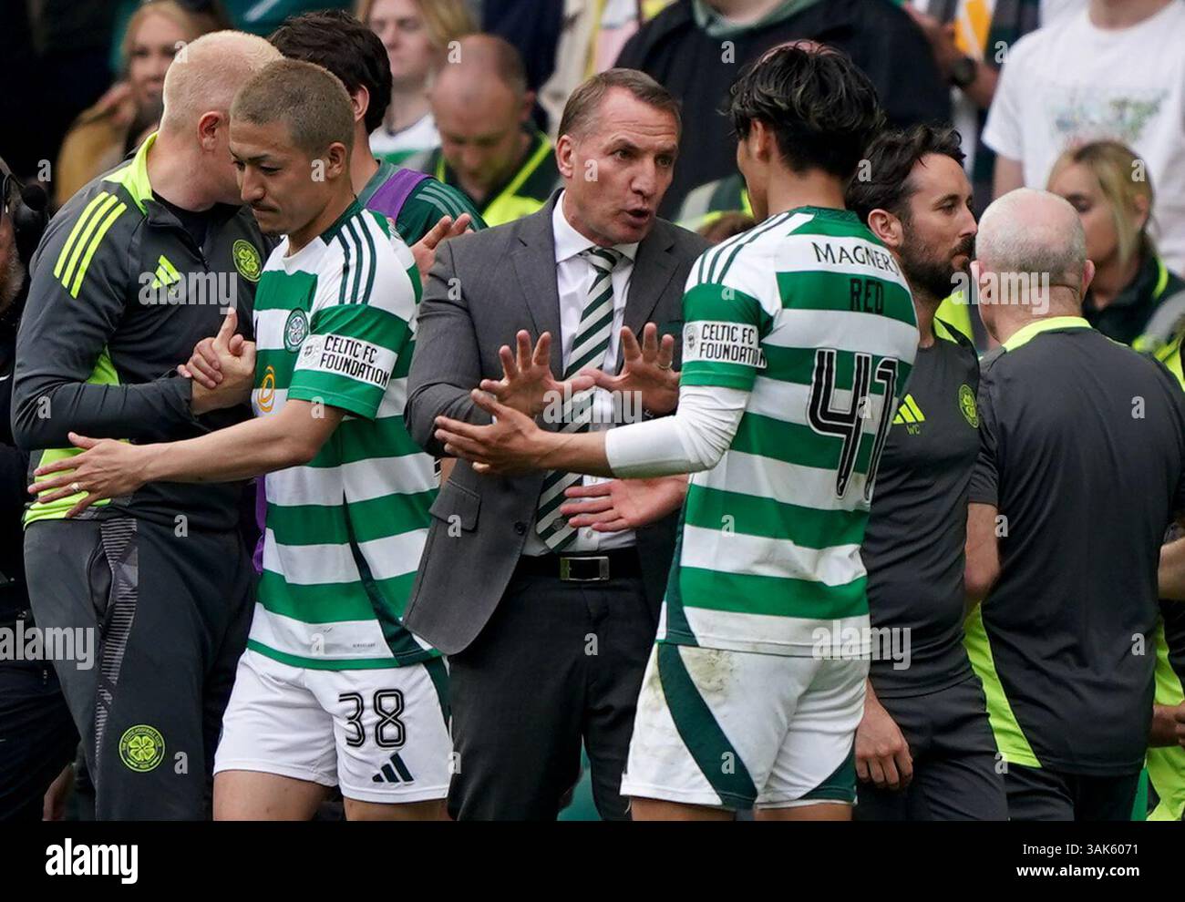 Celtic manager Brendan Rodgers (left) speaks with Reo Hatate after the ...