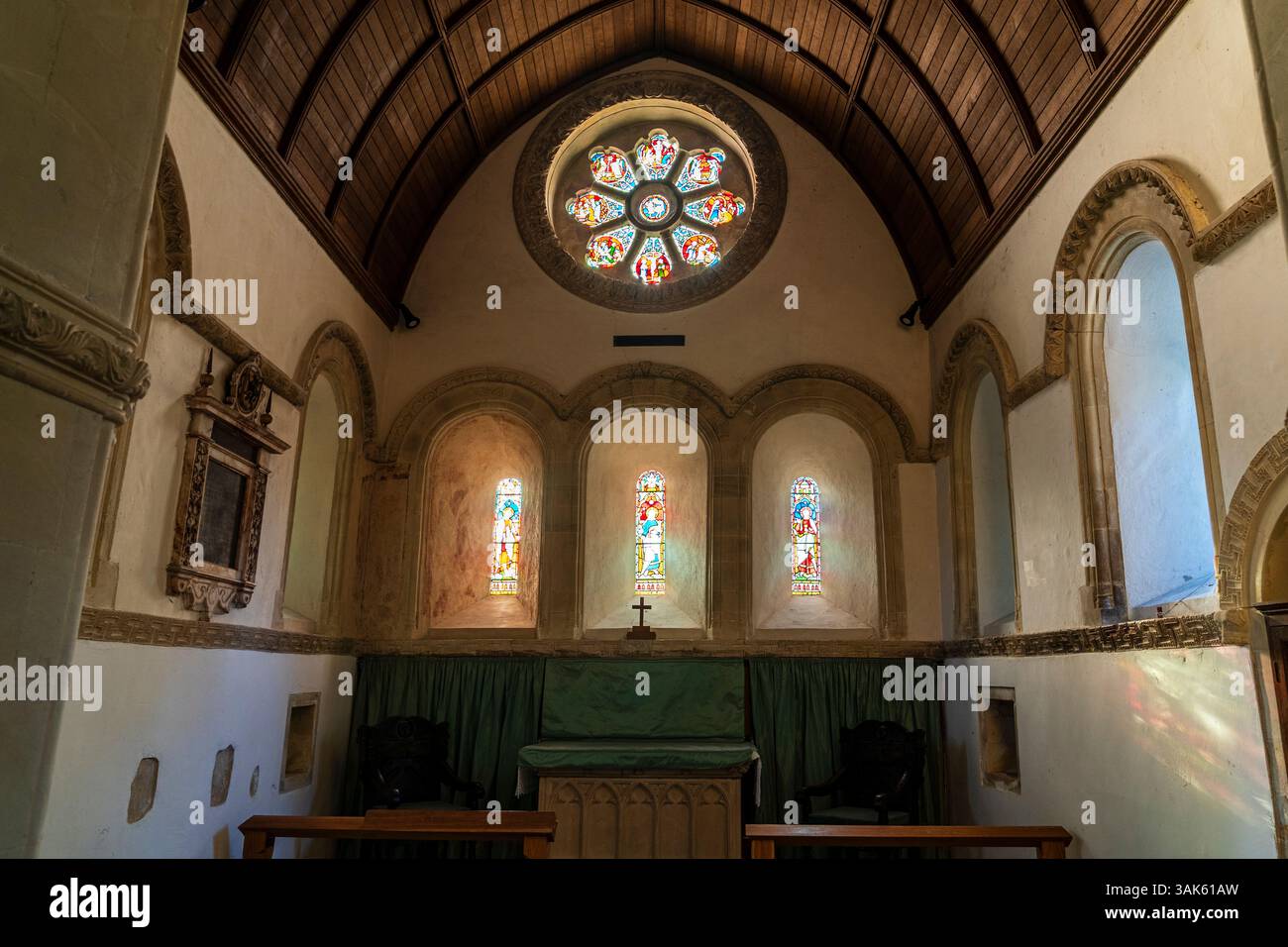 The modern stained glass in the windows of the Norman church at ...