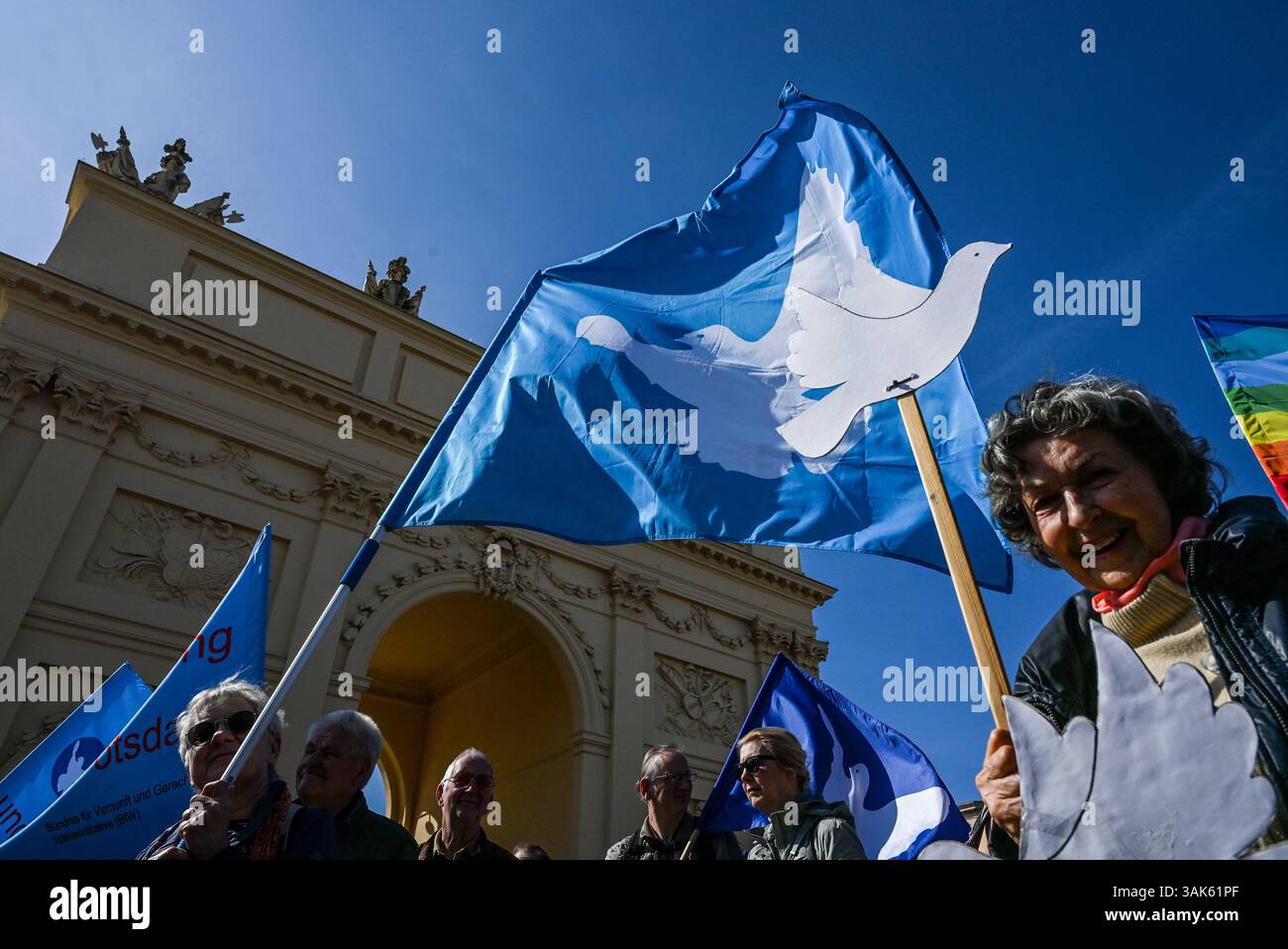 Potsdam, Germany. 12th Apr, 2025. Peace doves can be seen on flags and ...