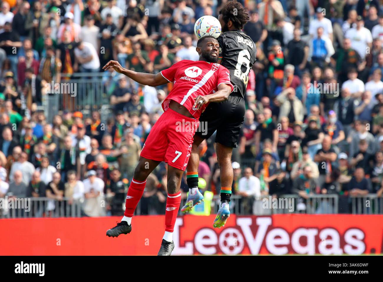 Monza's Jean-Daniel Akpa Akpro, left, and Venezia's Gianluca Busio jump ...