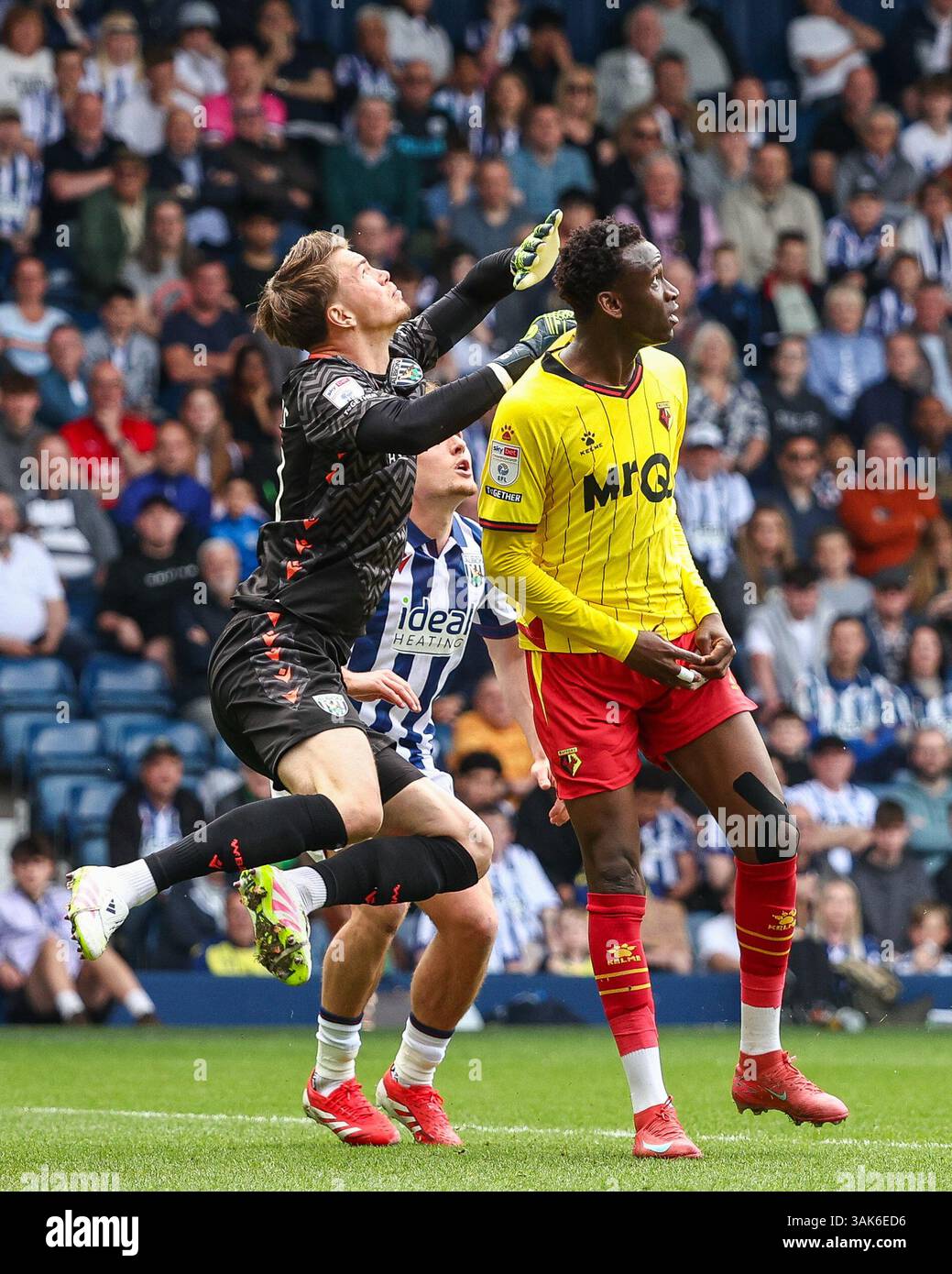 #20, goalkeeper Josh Griffiths of WBA is knocked off balance by the ...