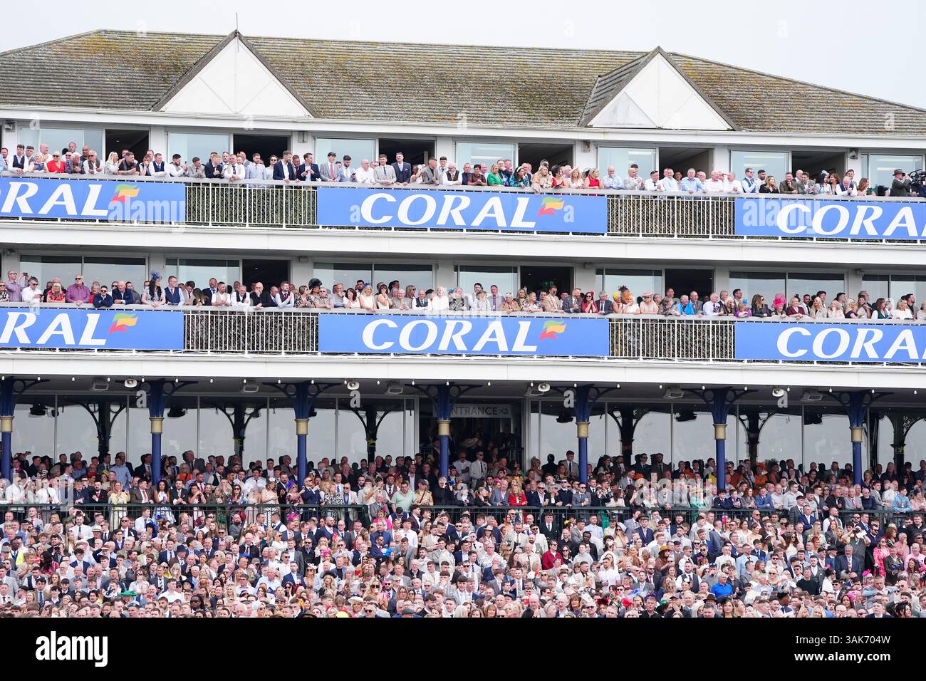Racegoers watch on in the stands on day two of the Coral Scottish Grand ...