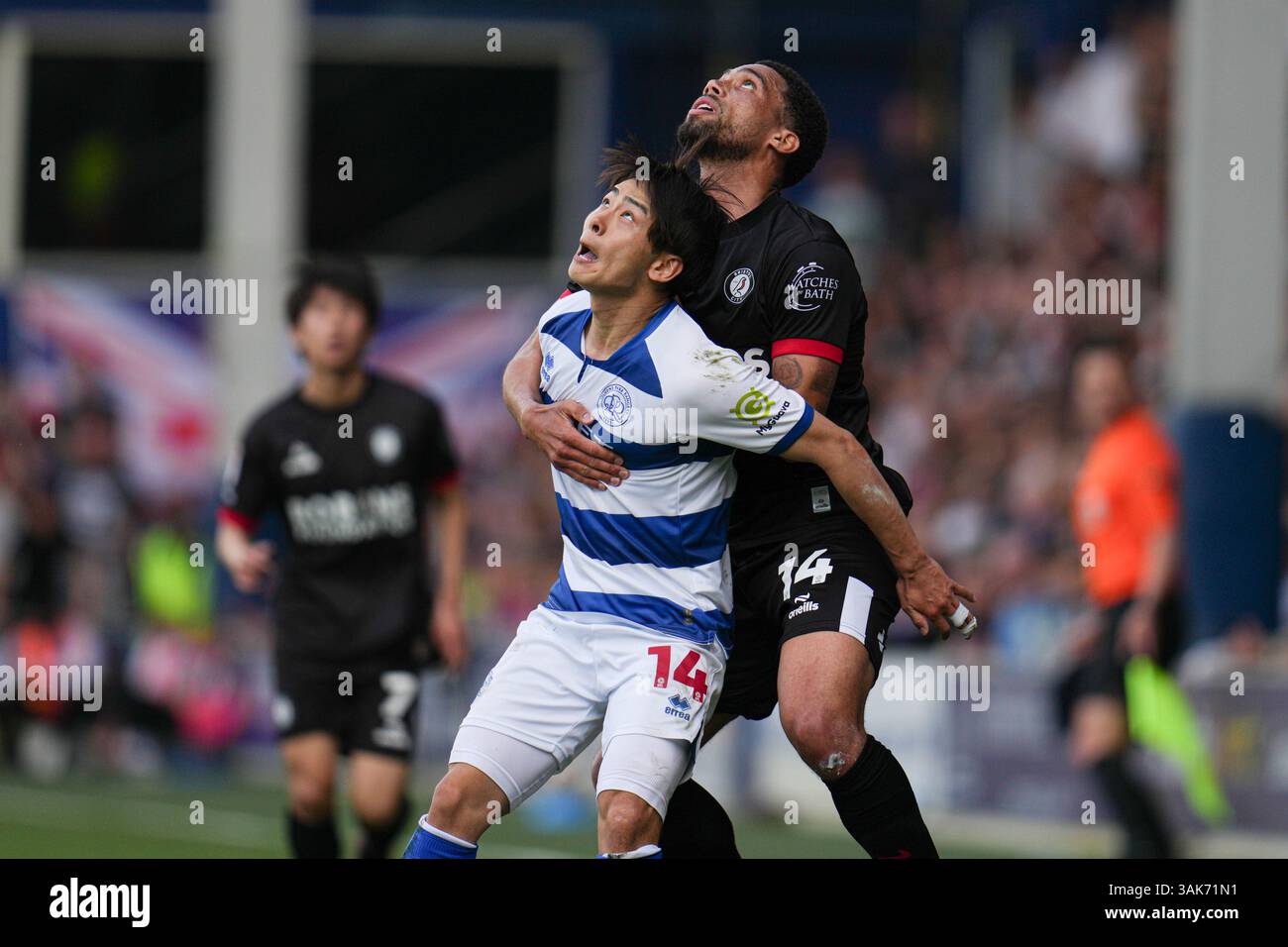 Koki Saito of Queens Park Rangers and Zak Vyner of Bristol City looking ...