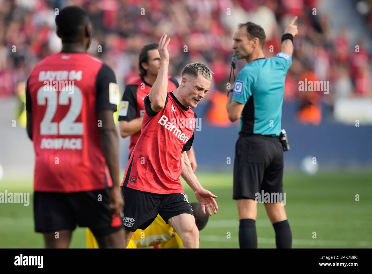 Leverkusen's Florian Wirtz, centre, reacts during the German Bundesliga ...