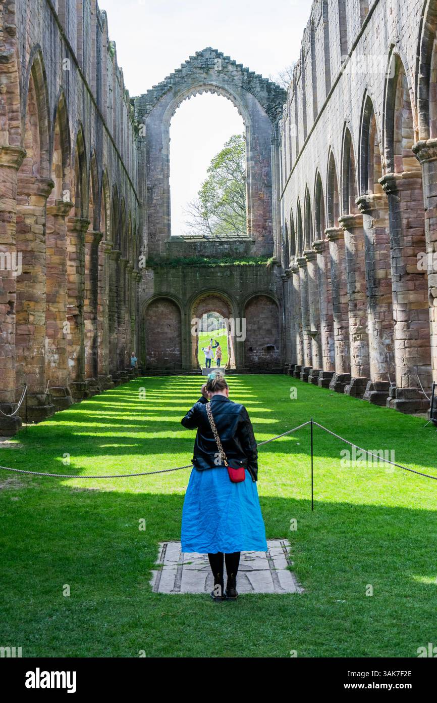 Yorkshire, UK. 12th Apr, 2025. Families enjoy the gardens and historic remains at Fountains ...