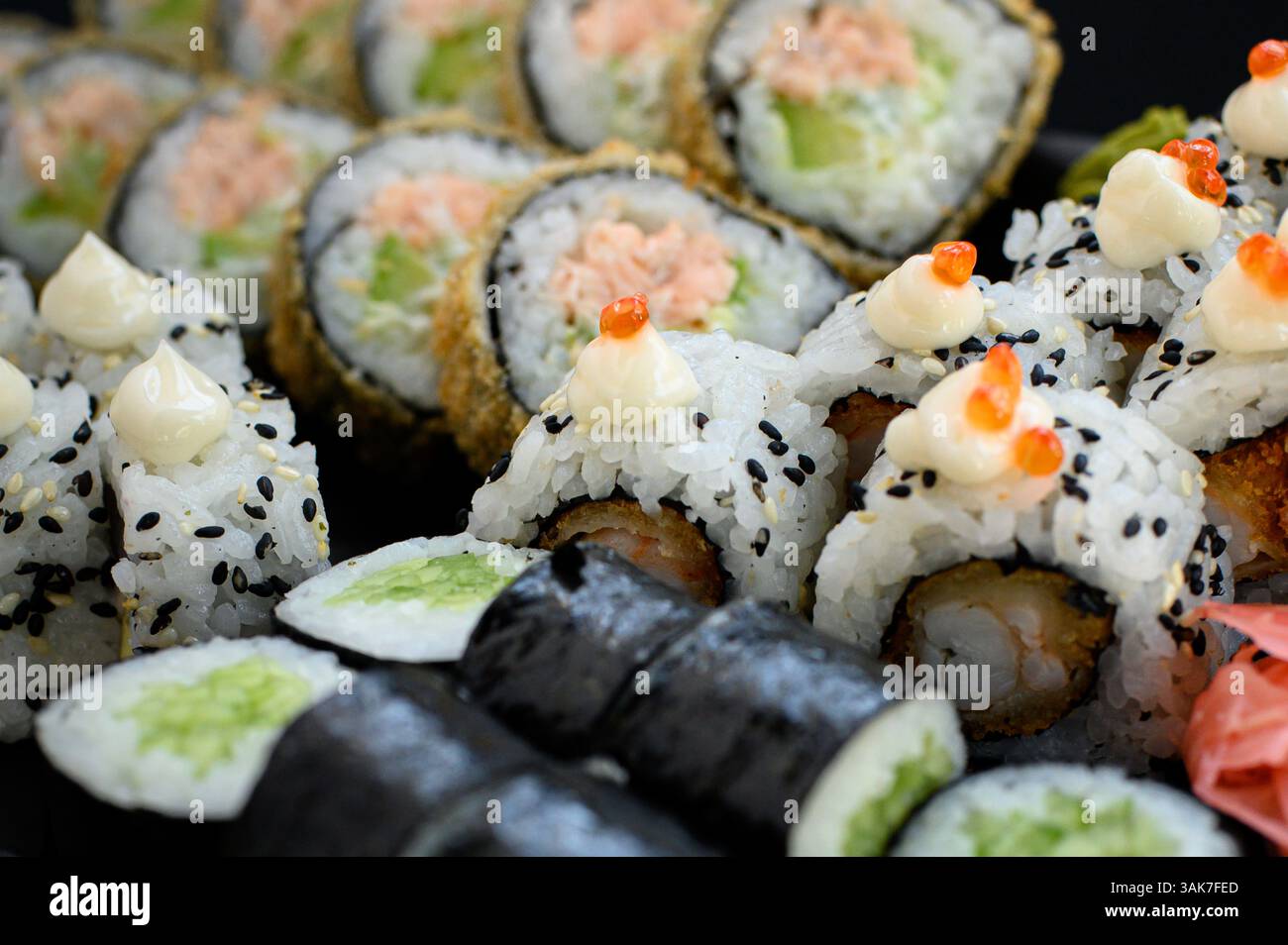 A classic sushi set with a variety of fresh rolls, served elegantly for ...