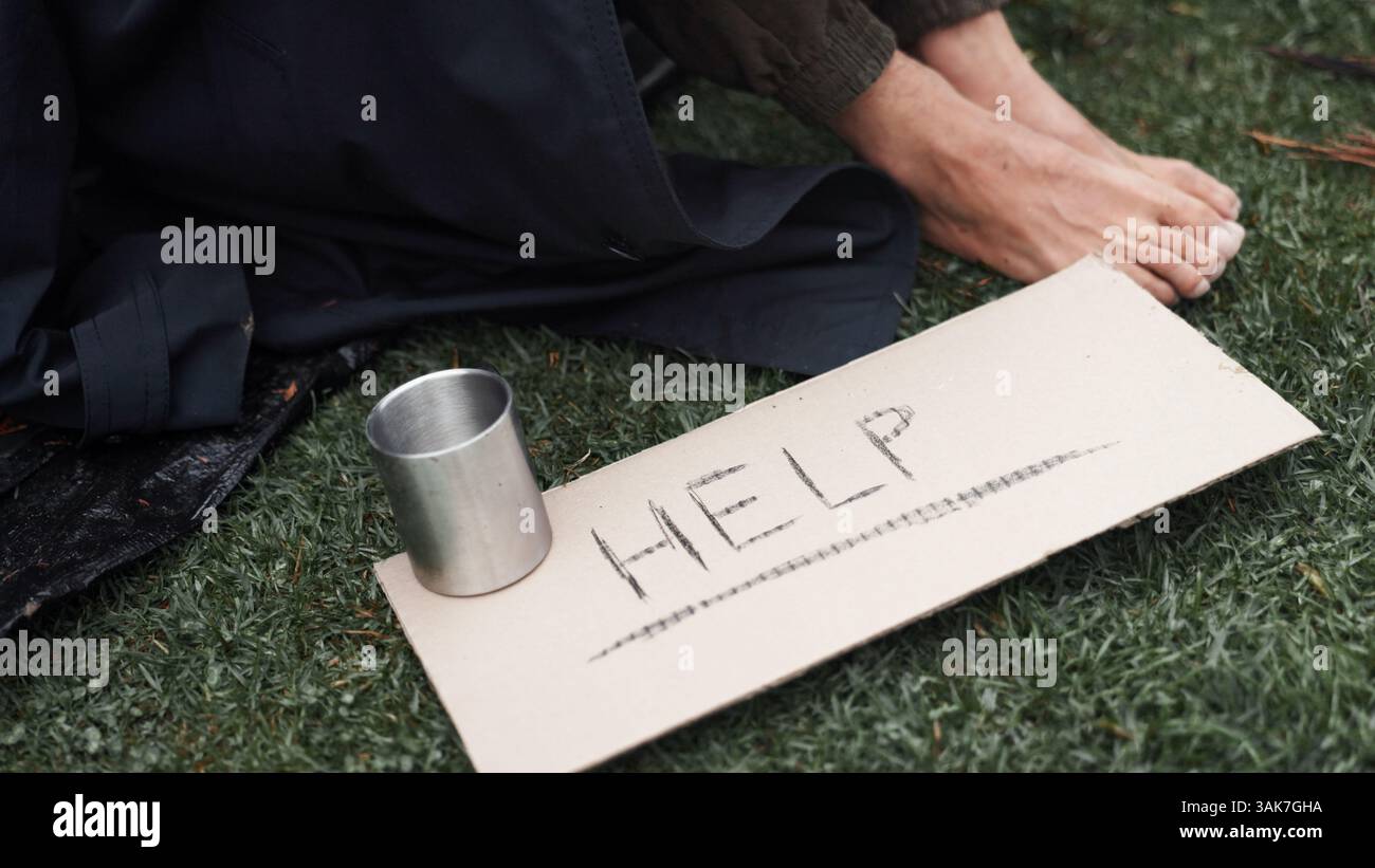 Person, homeless and cardboard sign for help, poverty and begging for ...