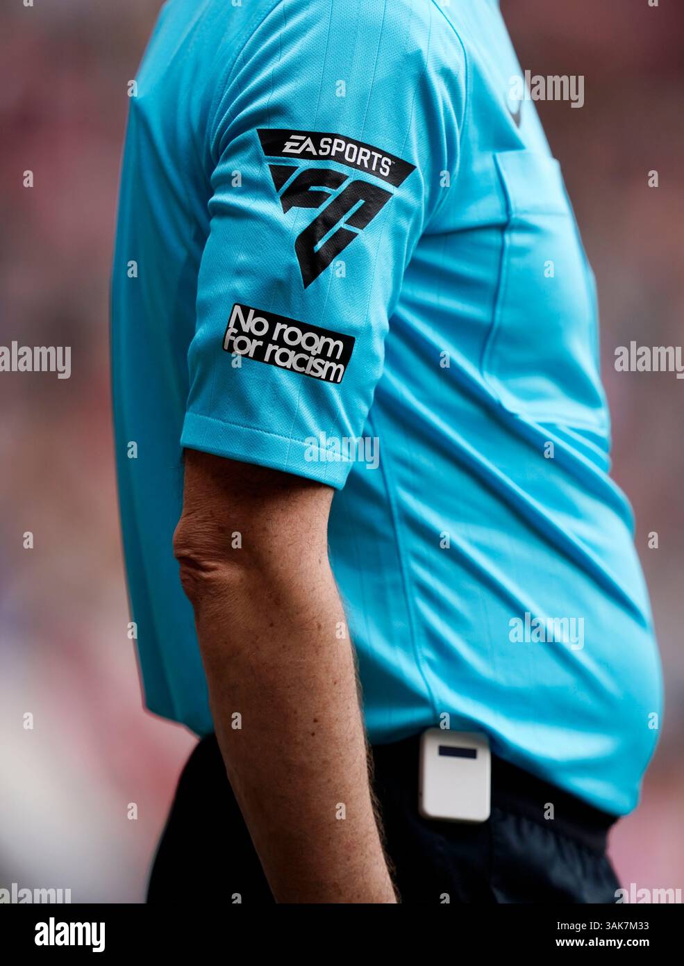 An official wearing a 'No room for racism' badge during the Premier ...