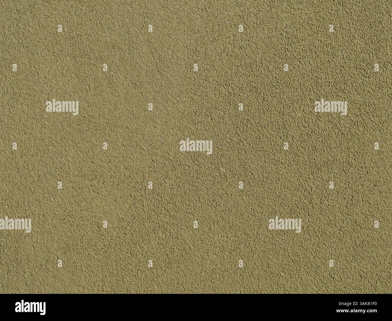 The wall is painted with a brown-green color and has a rough texture ...