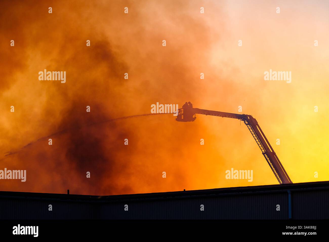 Flames and thick smoke rise from an industrial building in Mölndal ...