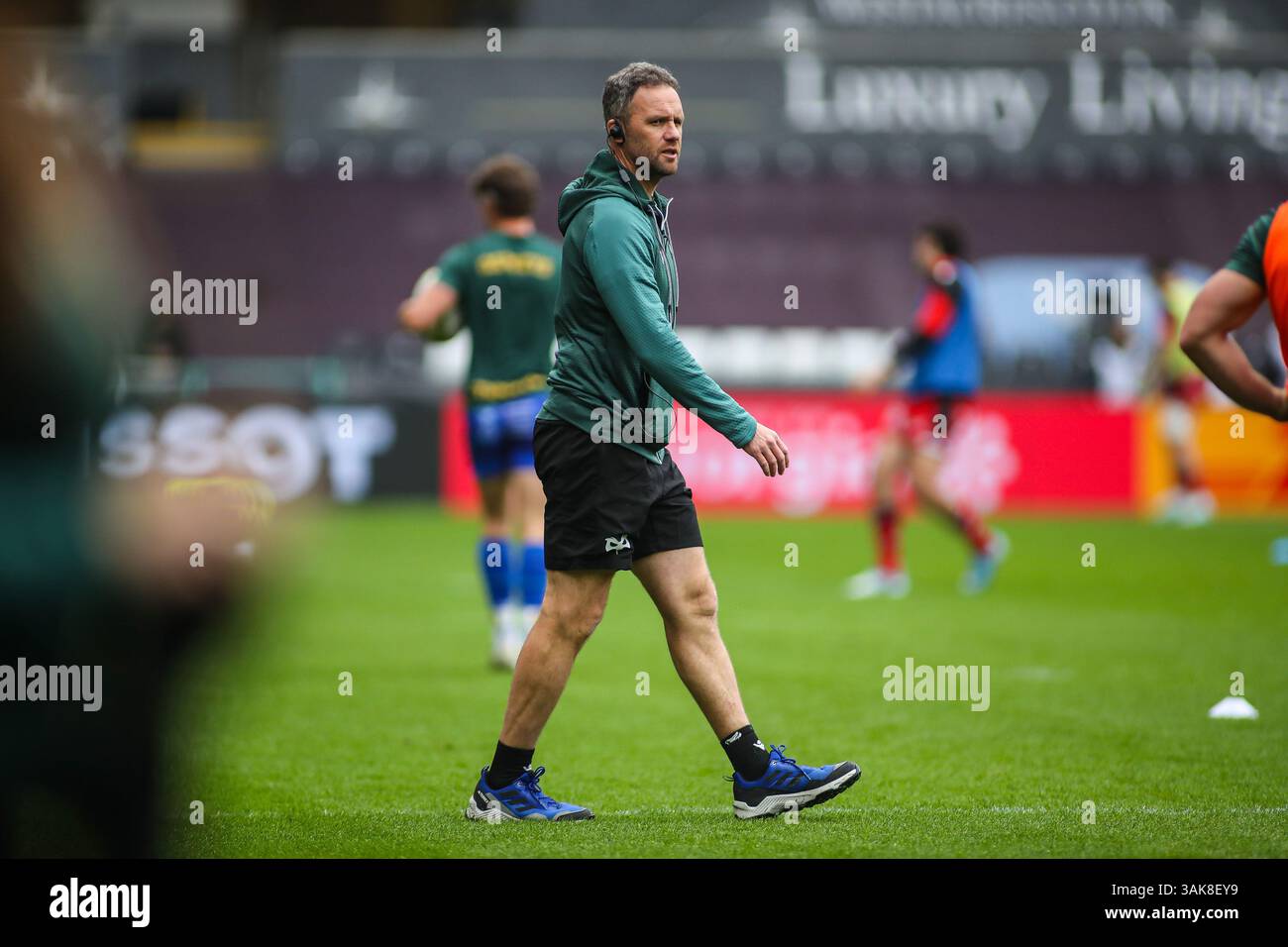 Swansea, Wales, UK. 12th April, 2025. Ospreys Head Coach Mark Jones ...