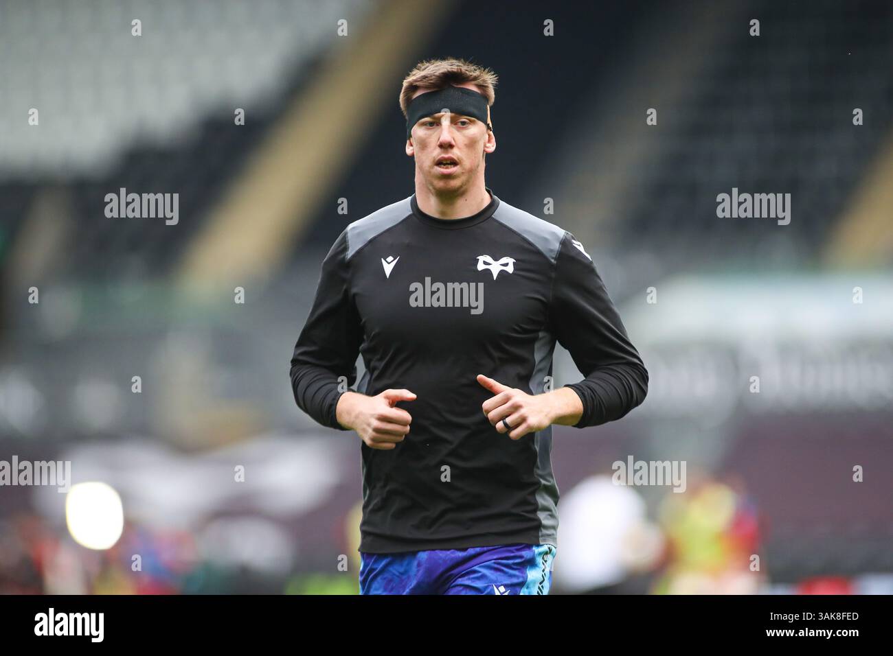Swansea, Wales, UK. 12th April, 2025. Adam Beard of Ospreys warms-up ...