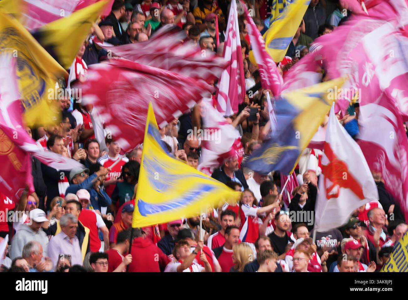 Fans wave flags before the English Premier League soccer match between ...