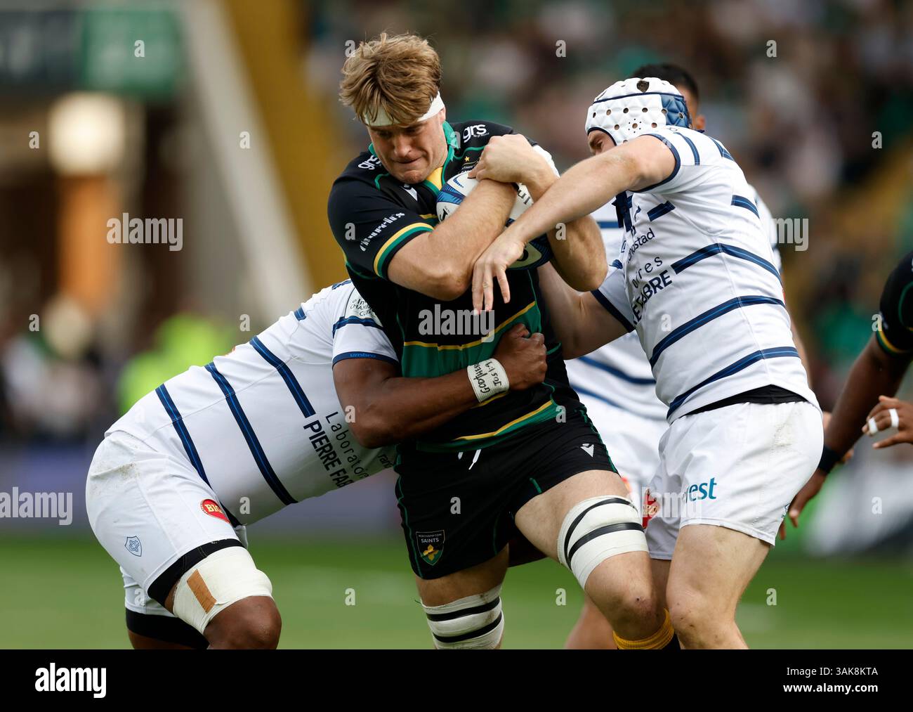 Northampton Saints' Alex Coles (centre) tackled by Castres Olympique's ...