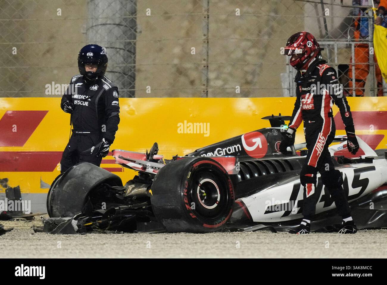 Haas driver Esteban Ocon of France walk after a crash during the ...