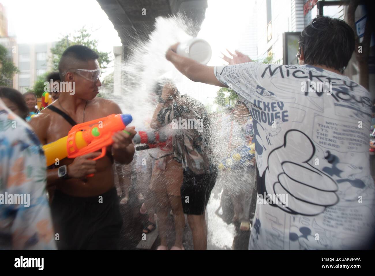 People Enjoying water gun fight during Songkran Festival at Silom Road ...