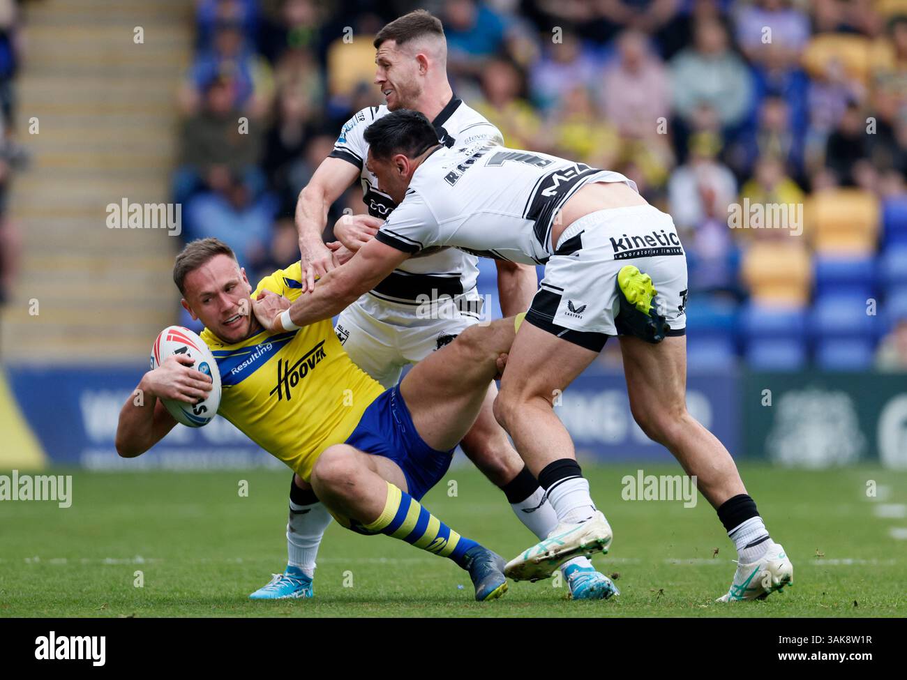 Warrington Wolves' Ben Currie (left) is tackled by Hull FC's Jordan Rapana (right) during the ...