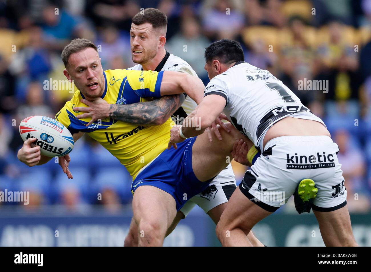 Warrington Wolves' Ben Currie (left) is tackled by Hull FC's Jordan ...