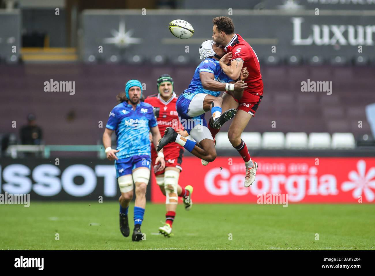 Swansea, Wales, UK. 12th April, 2025. Daniel Kasende of Ospreys and Léo ...