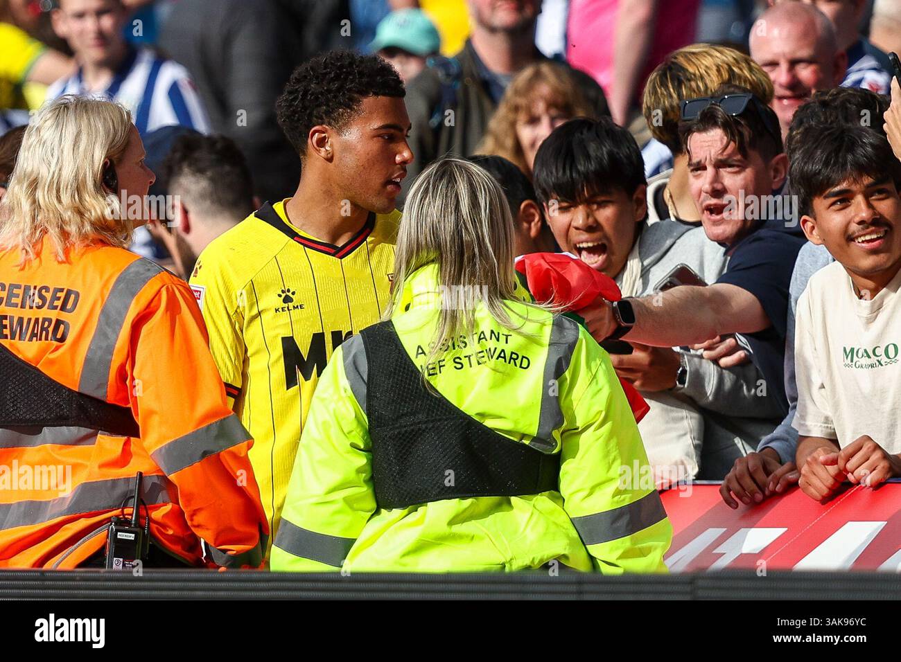#26, Caleb Wiley of Watford signs autographs after the game after the ...