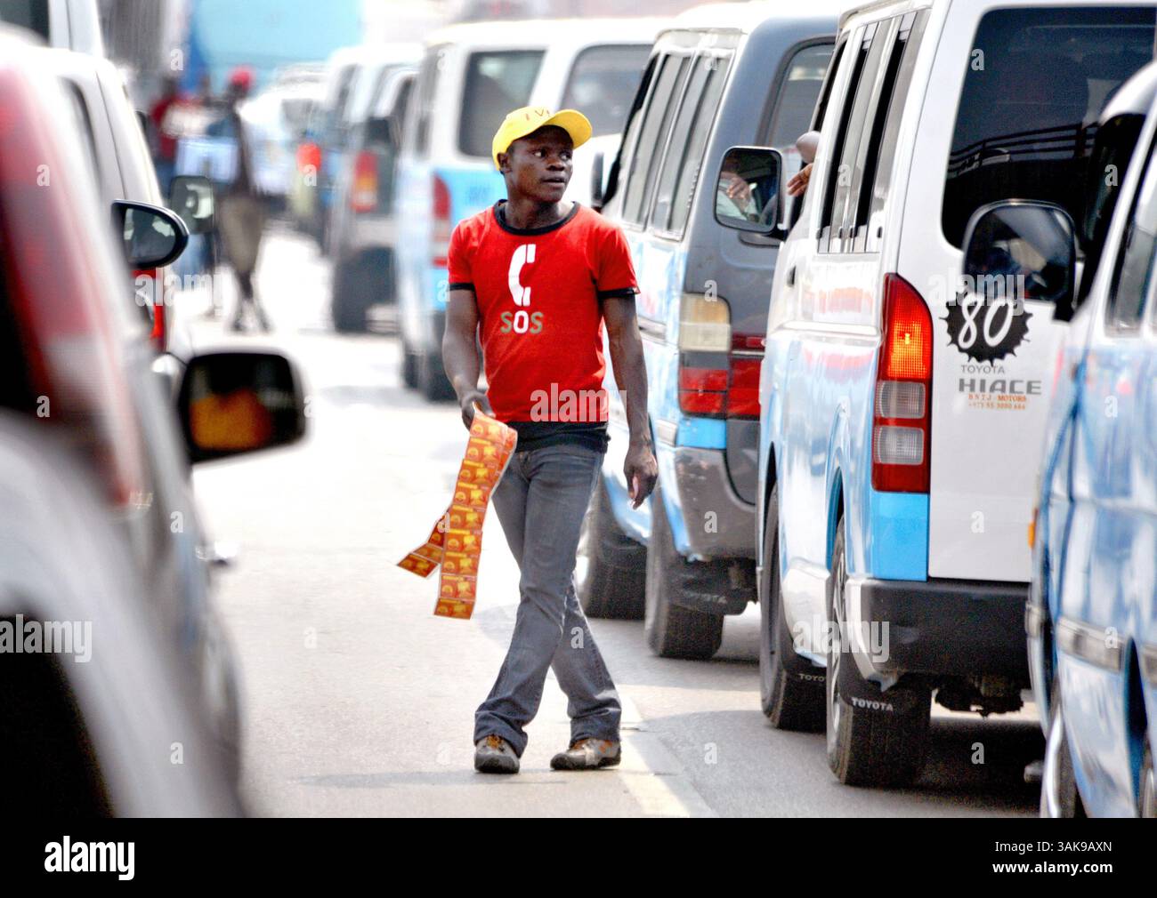 July 5, 2013 - Luanda, Angola - A street vendor weaves his way through ...