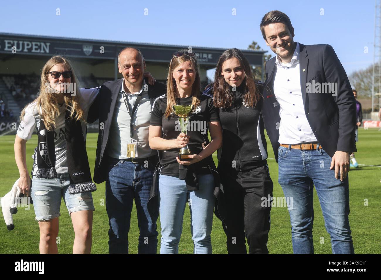 The Eupen women's team receives a trophy during halftime in celebration ...