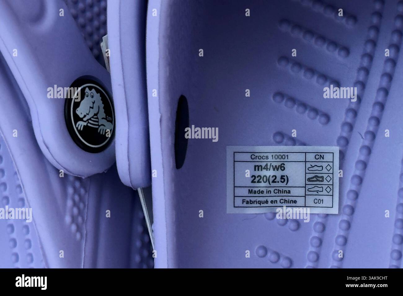 A Crocs shoe with a sticker showing made in China, is displayed on sale ...