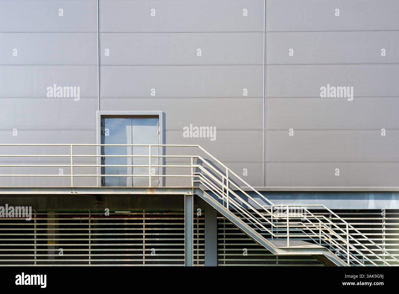 Modern warehouse building with metal stairs to entrance Stock Photo - Alamy