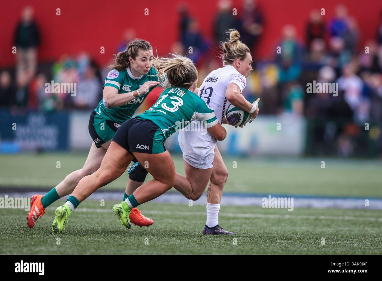 Cork, Ireland. 12 April, 2025. Megan Jones of England is tackled by Aoife Dalton of Ireland ...