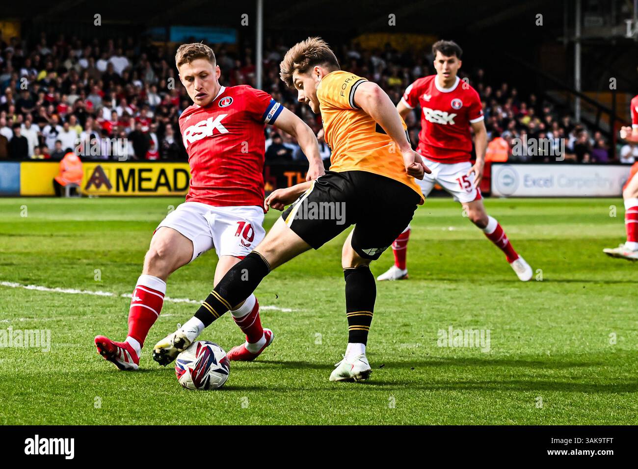 Josh Stokes (22 Cambridge United) challenged by Greg Docherty (10 ...