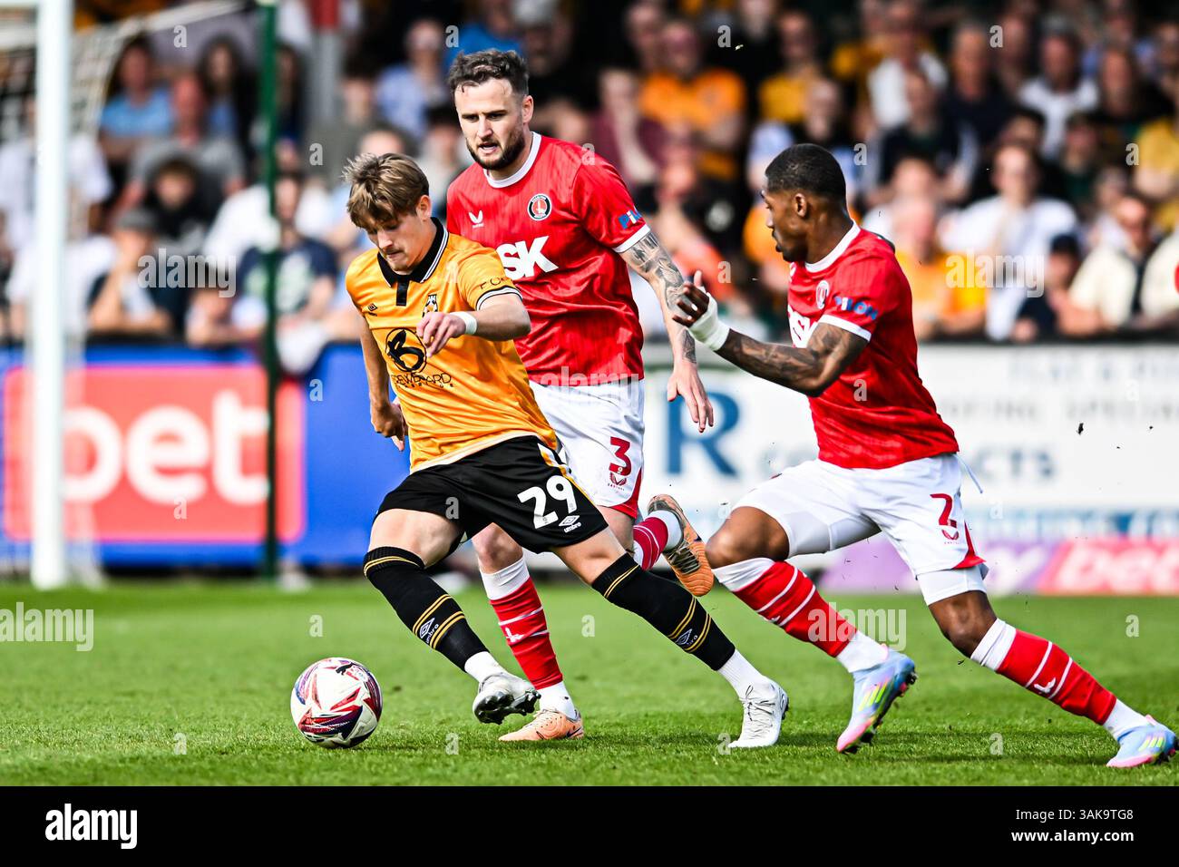 Dom Ballard (29 Cambridge United) challenged by Kayne Ramsay (2 ...