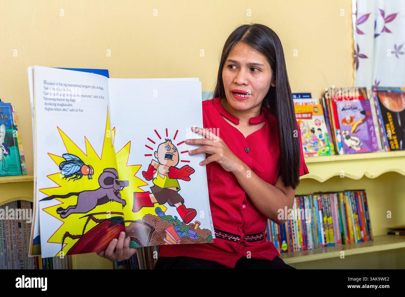 A public elementary school teacher in Batangas, Philippines reads to ...