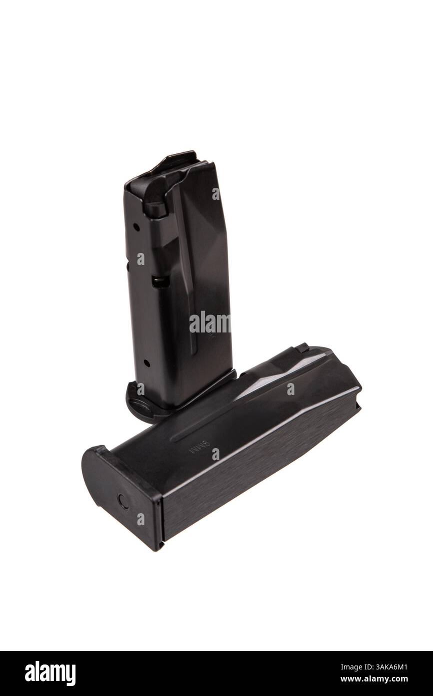 Two black 9mm pistol magazines on white background, one standing ...