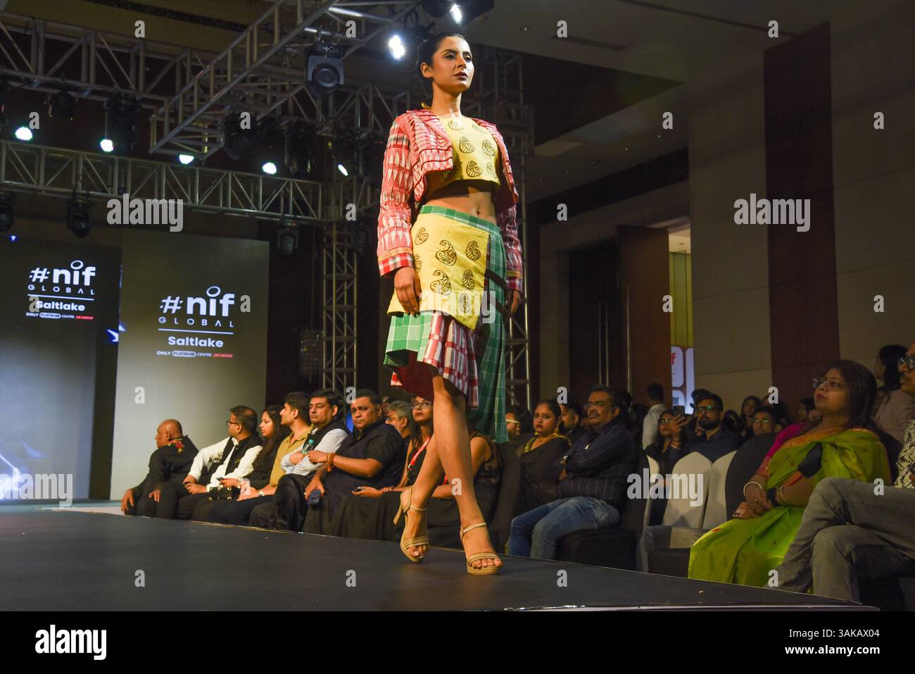 An Indian model displays the new summer collection at the NIF Global Elixir 2025 Fashion Show in ...