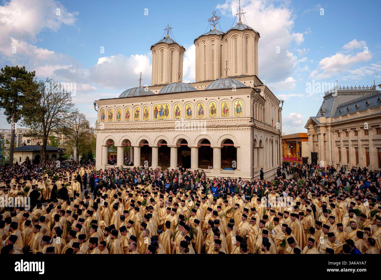 Romanian Orthodox priests and believers stand outside the Patriarchal ...