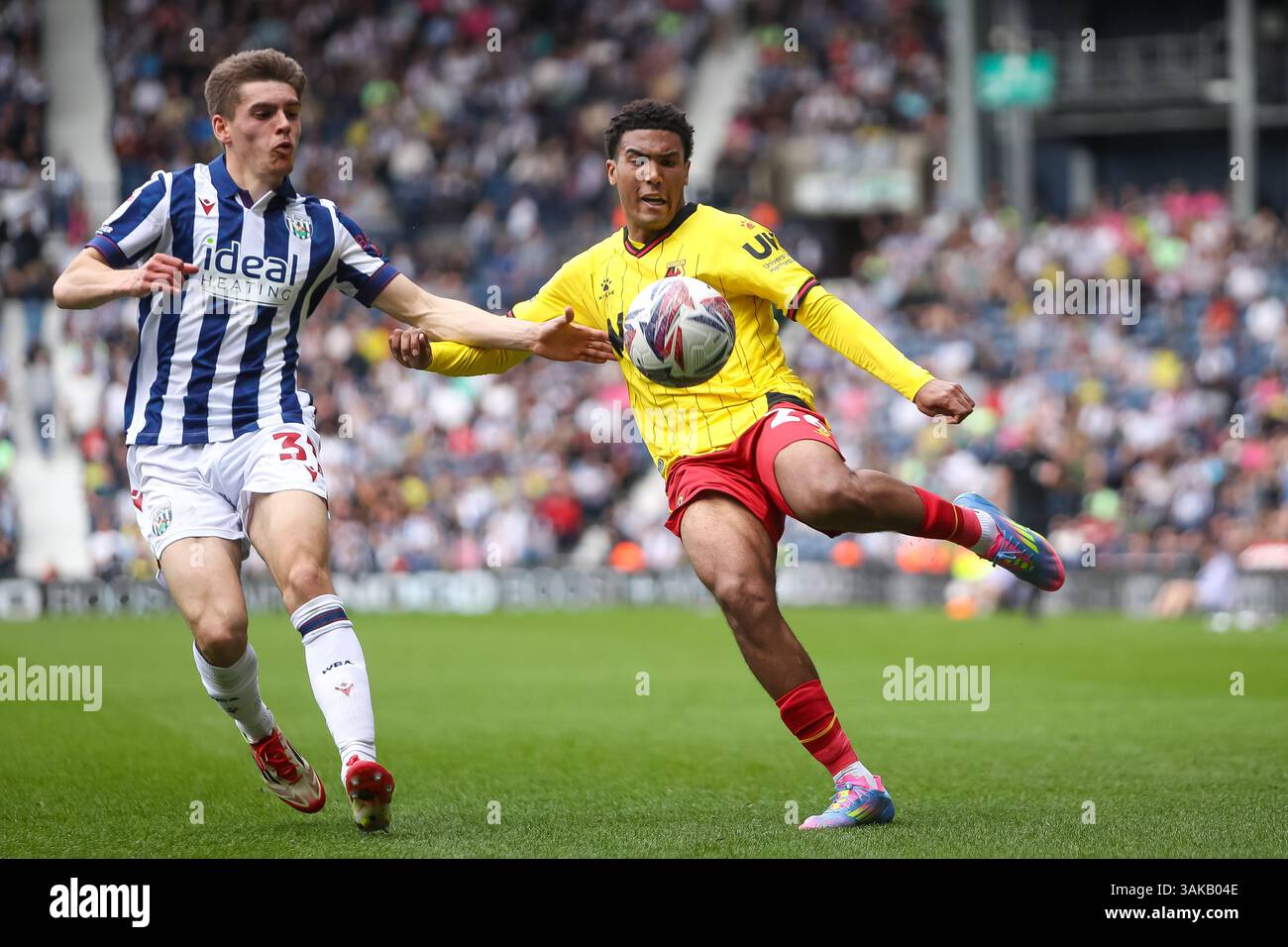 Caleb Wiley of Watford crosses the ball against Tom Fellows of West ...