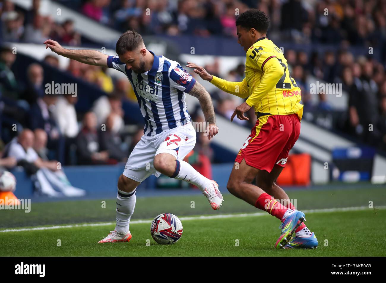 Adam Armstrong of West Bromwich Albion is closed down by Caleb Wiley of Watford during the EFL ...