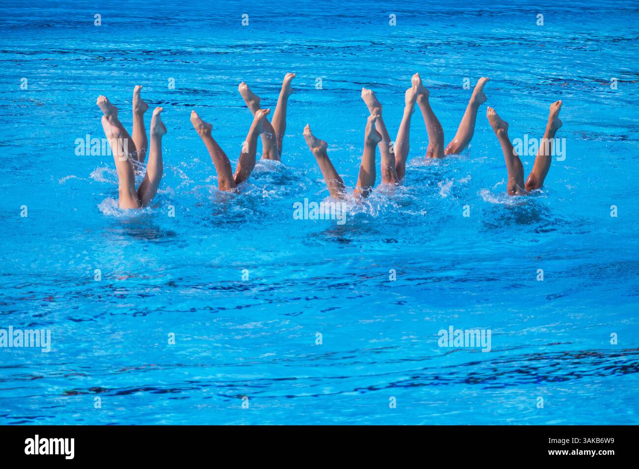 Synchronized or artistic swimmers performing an elegant and precise ...