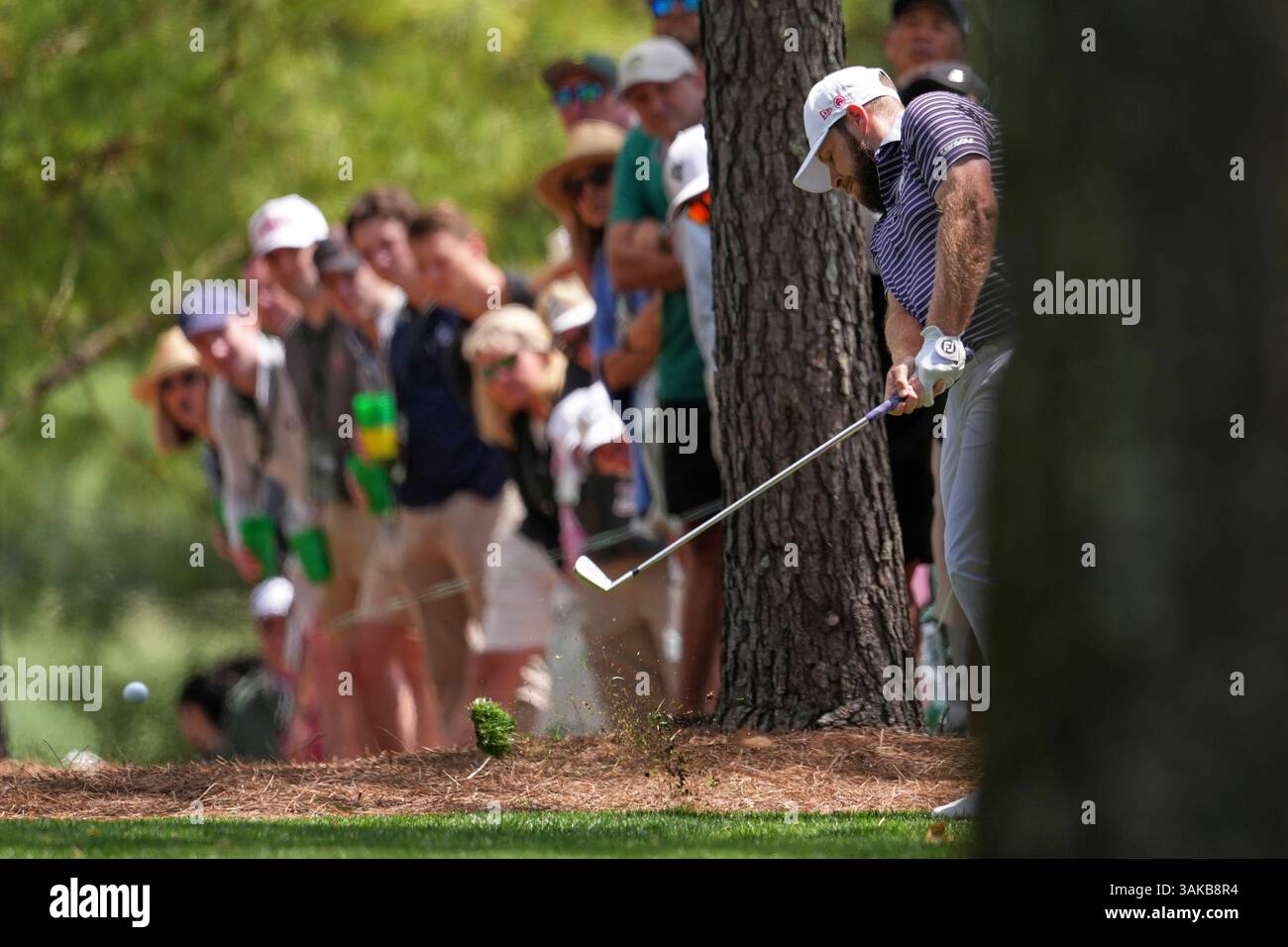 Tyrrell Hatton, of England, hits from the rough on the first hole ...