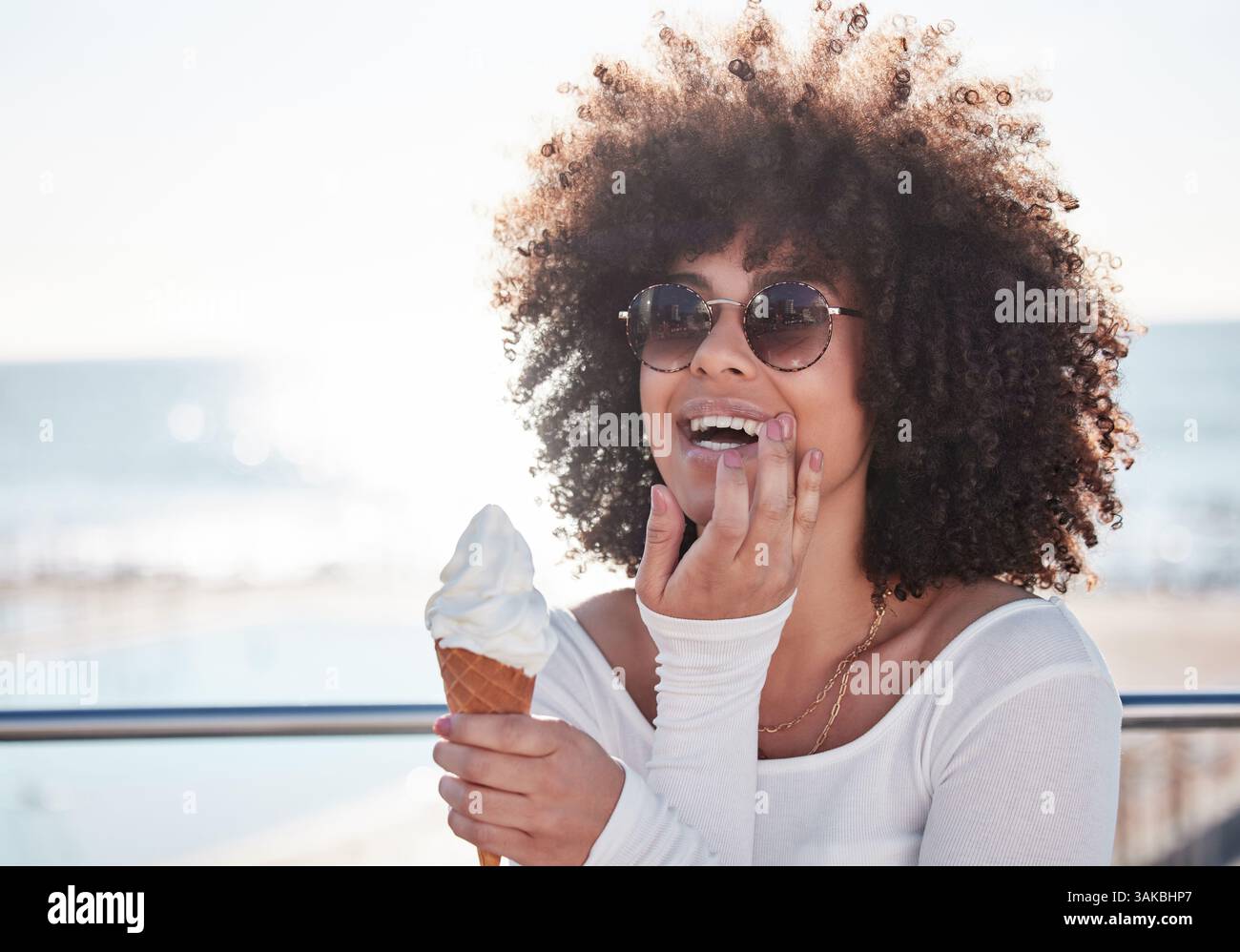 Happy, ice cream and black woman by sea on a promenade with student ...