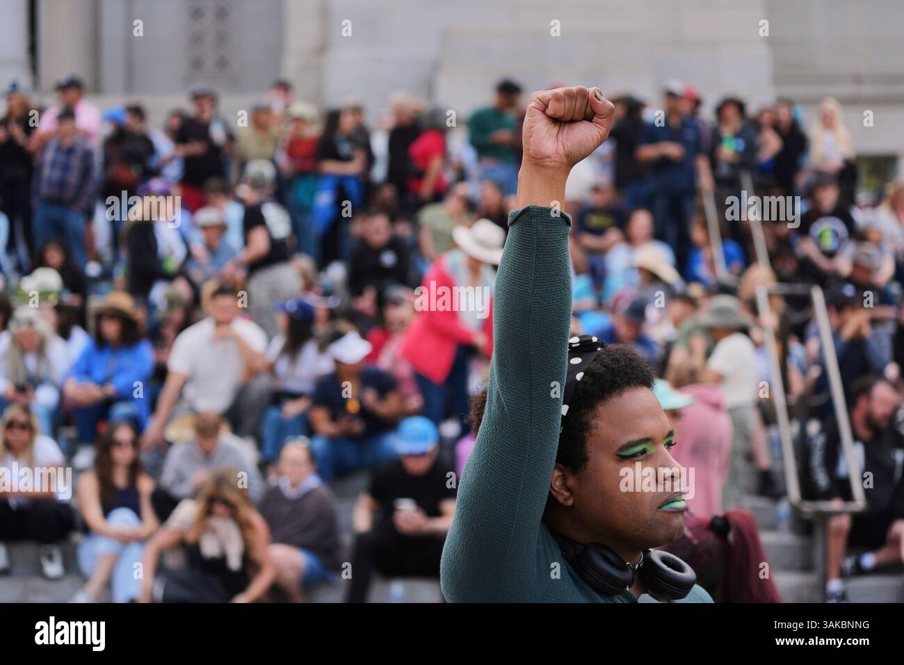 A person who goes by Mocha Jay holds up a fist during a "Fighting ...