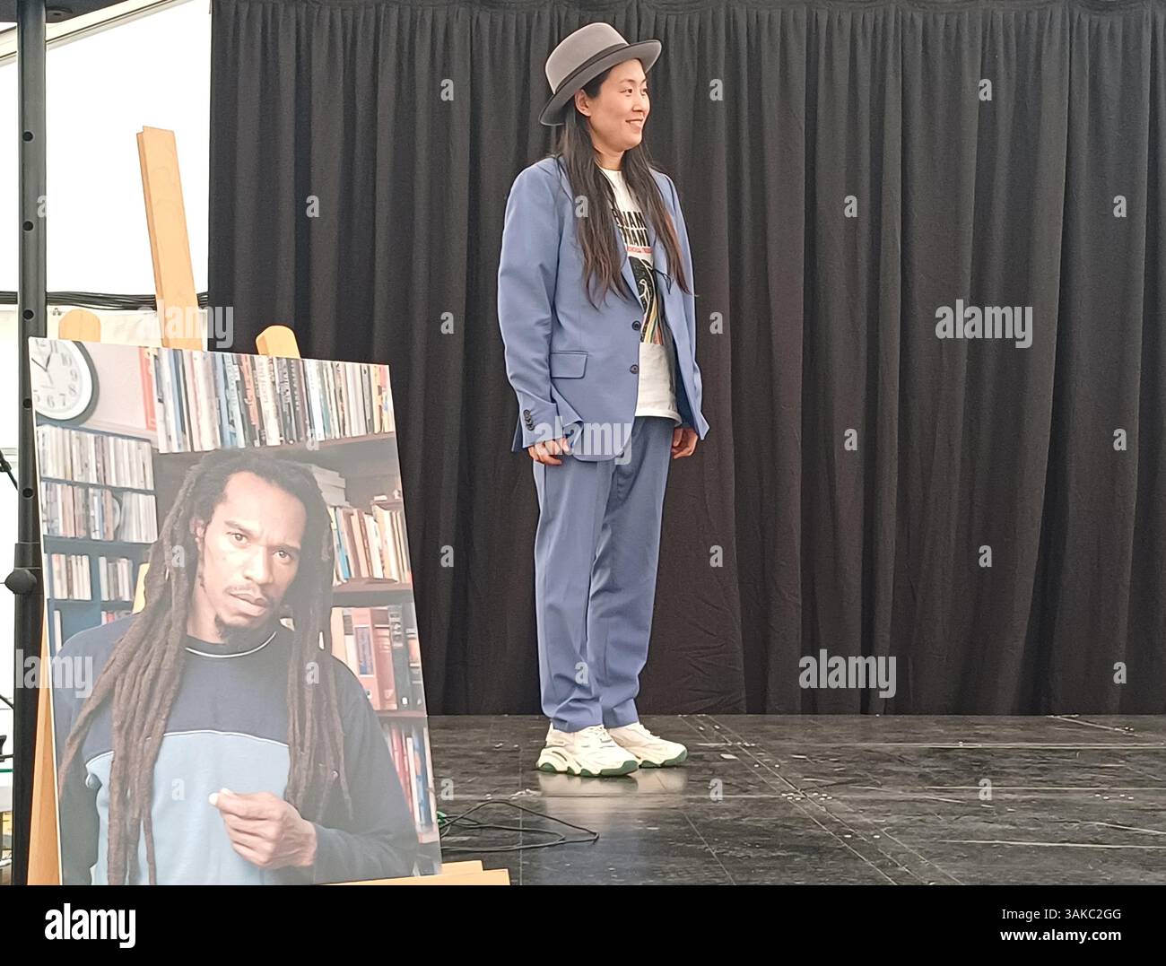 Qian Zephaniah, Zephaniah's widow, wearing one of his suits and a hat ...
