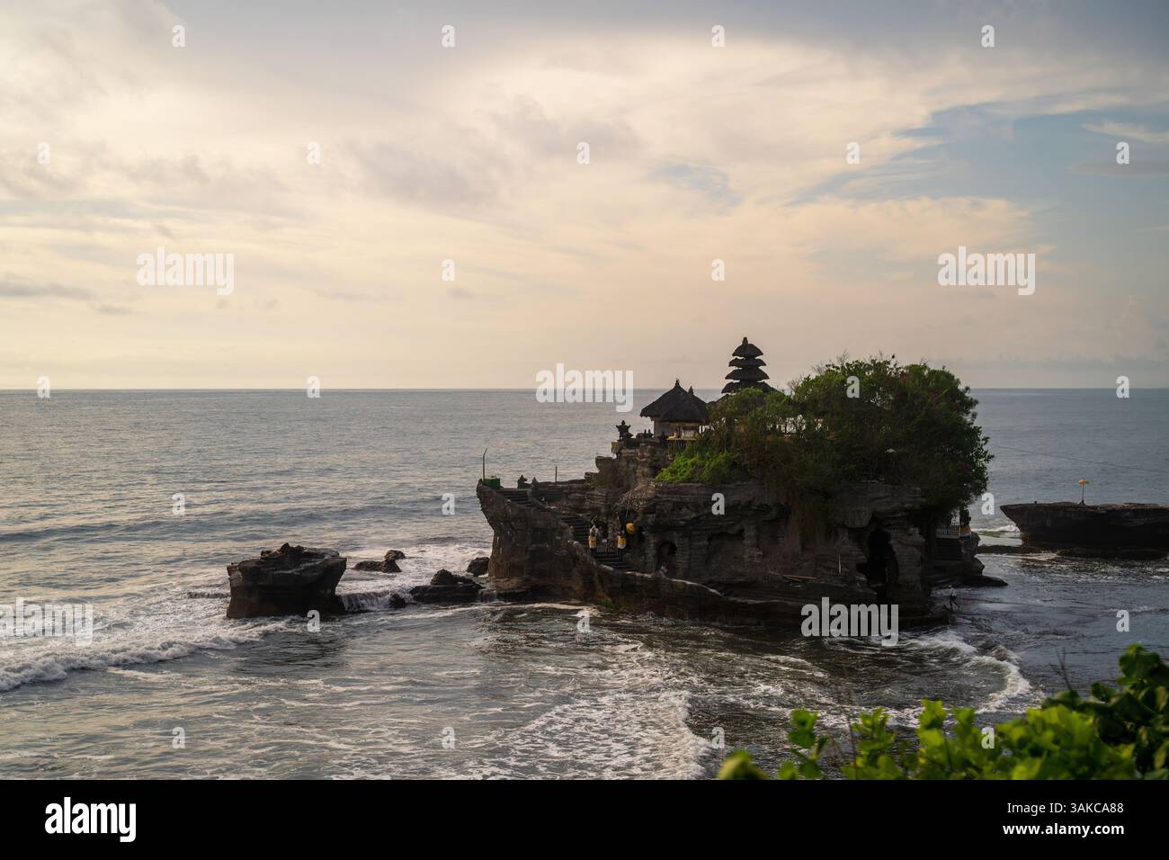 Iconic Tanah Lot sea temple built on dramatic offshore rock formation ...