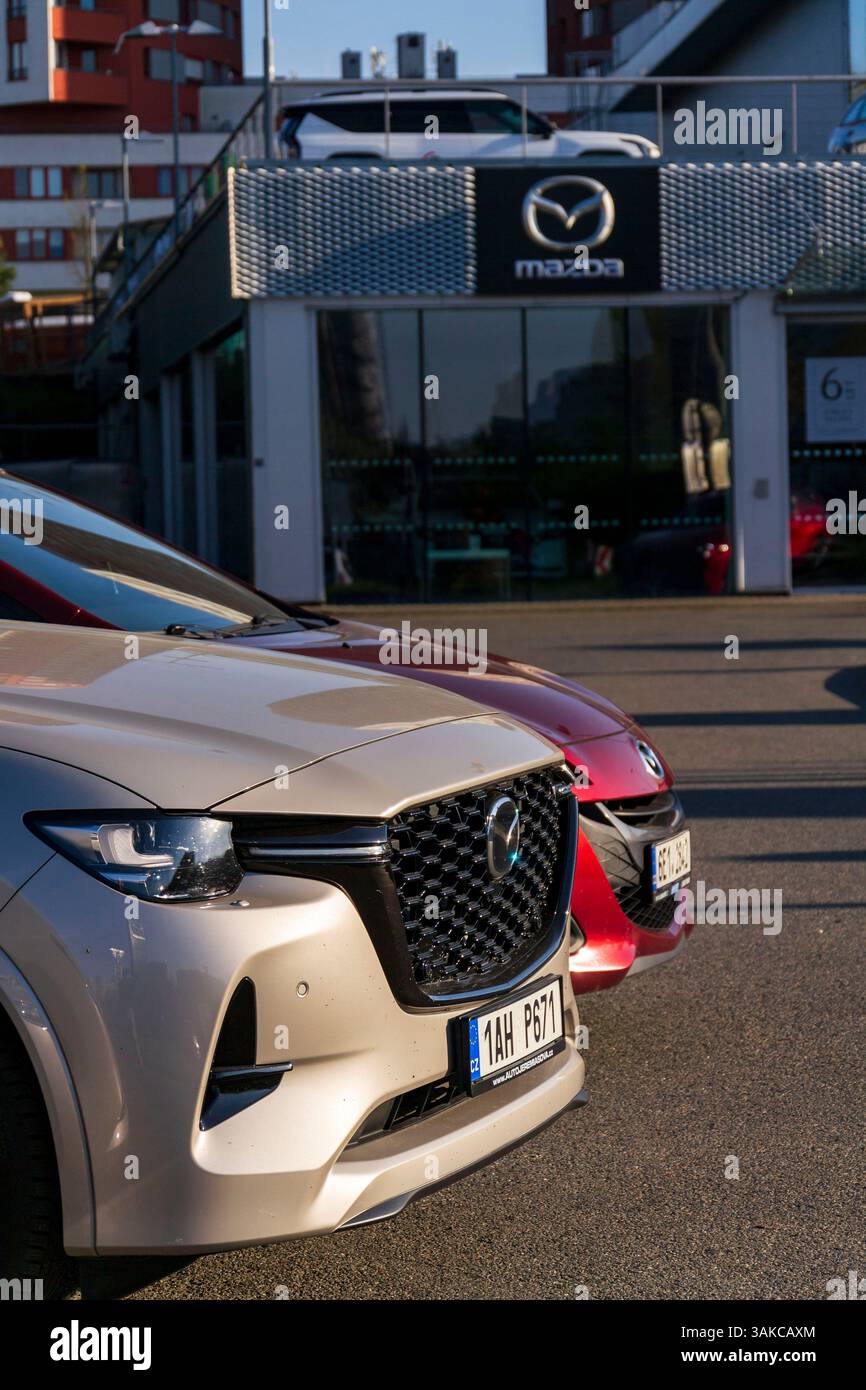 Mazda Motor Corporation logo on car in front of dealership building on ...